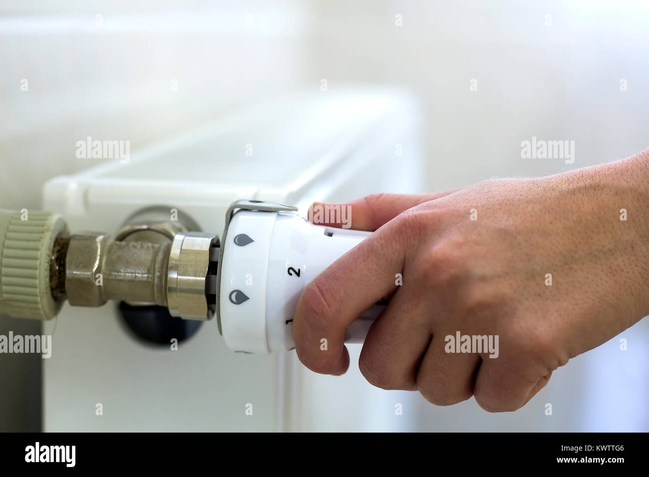 Hand adjusting the valve knob thermostat of heating radiator Stock ...