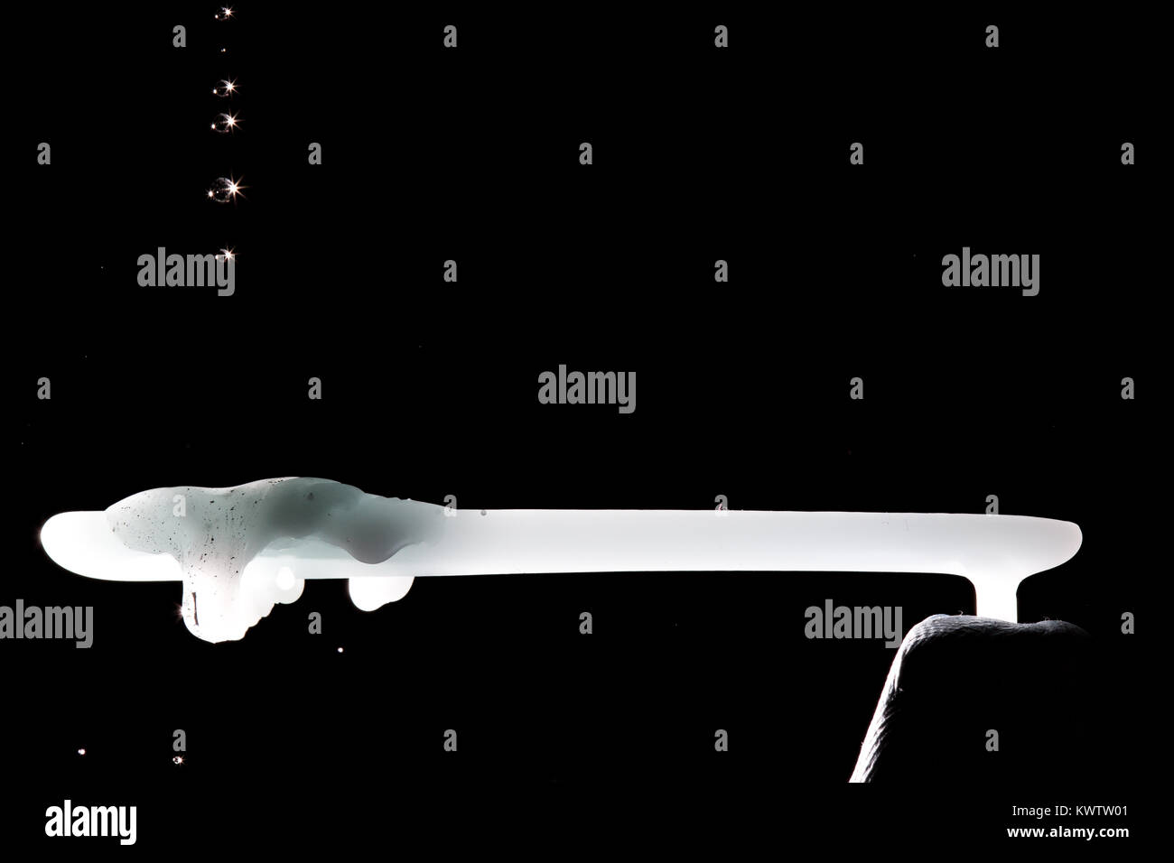 Dripping wax on horizontal bar shaped figure Stock Photo - Alamy