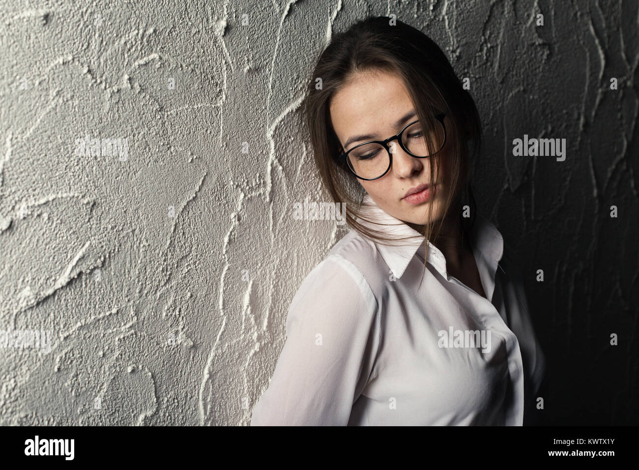 beautiful sad girl portrait near white wall Stock Photo - Alamy