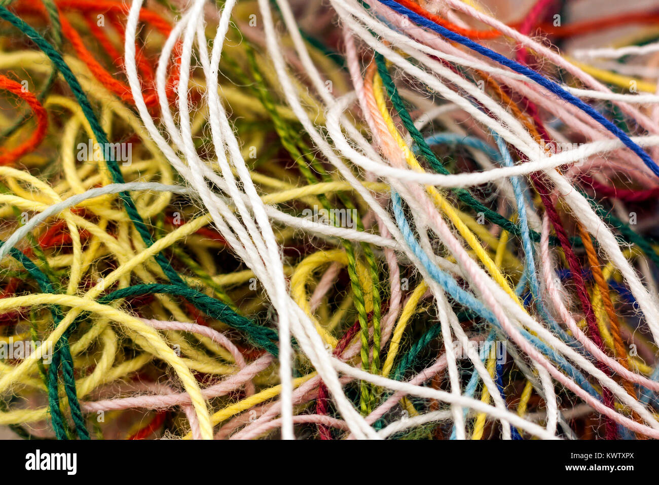 Multi-colored tangled colorful needlecraft silk thread rope. Macro shot ...
