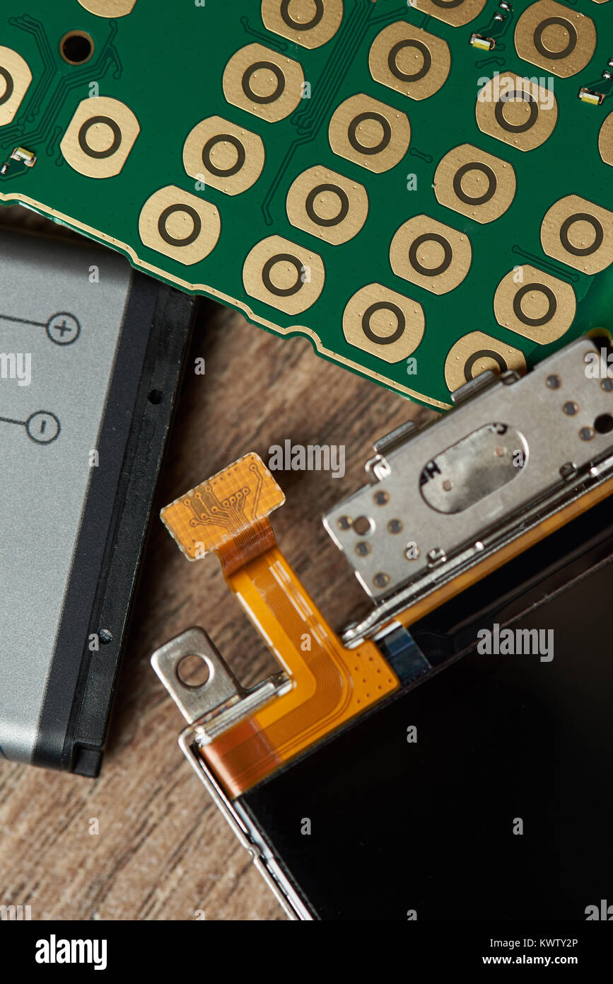 Main parts of mobile phone close up. Battery, board and screen of ...