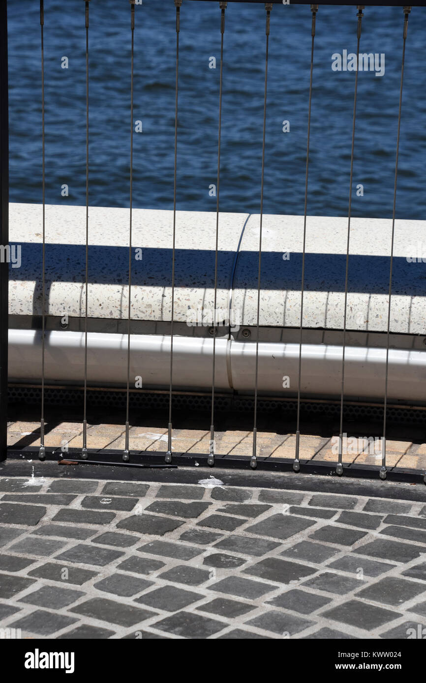 DIscarded Straw underneath a railing Stock Photo - Alamy