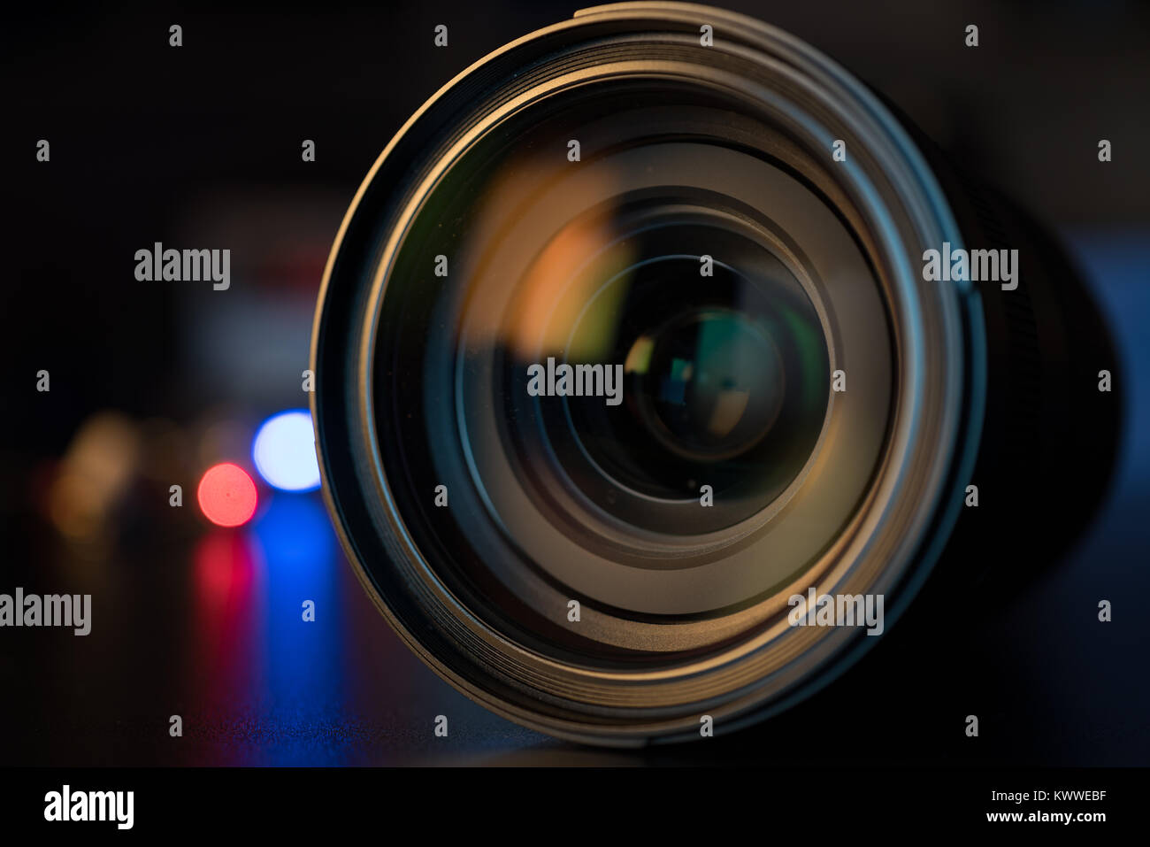 The photo or videocamera lens on dark background with lense reflections ...