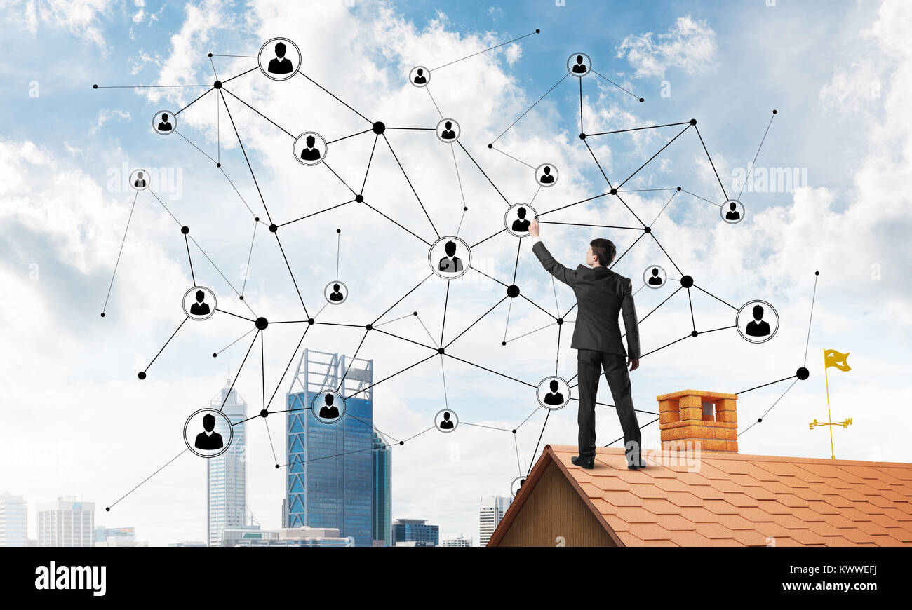 Businessman on house roof presenting networking and connection concept ...