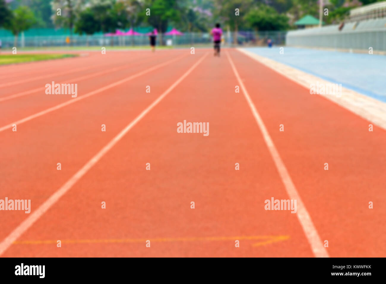 Blurred runner jogging on track in evening Stock Photo - Alamy
