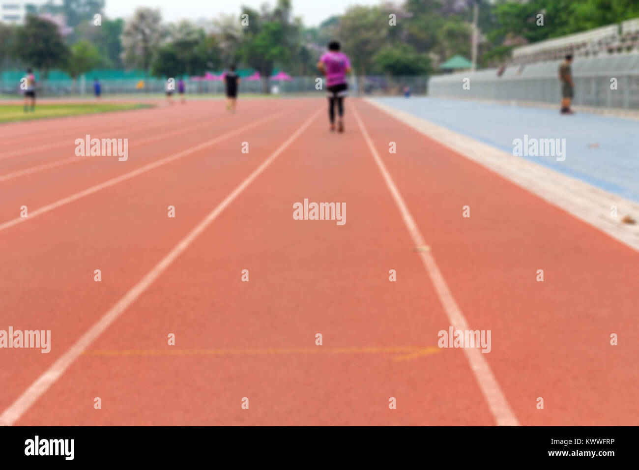 Blurred runner jogging on track in evening with copy space Stock Photo ...