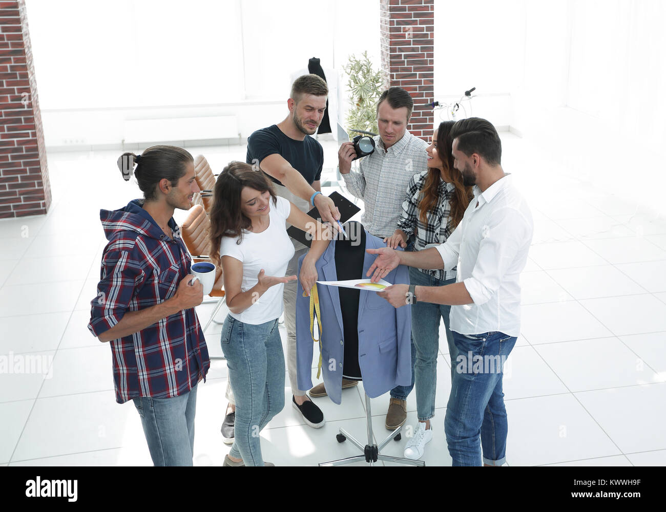 group of designers working with new models of men's clothing. photo ...