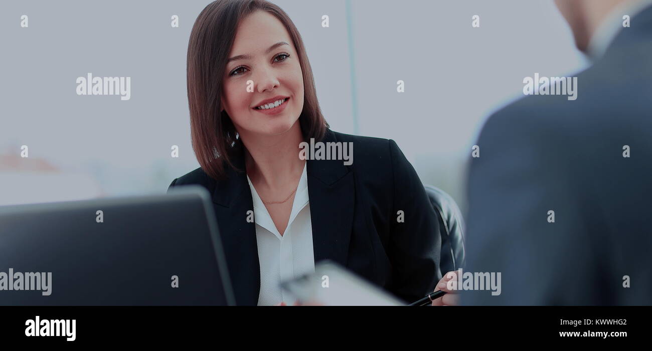Beautiful young businesswoman conducting a job interview seated at her ...