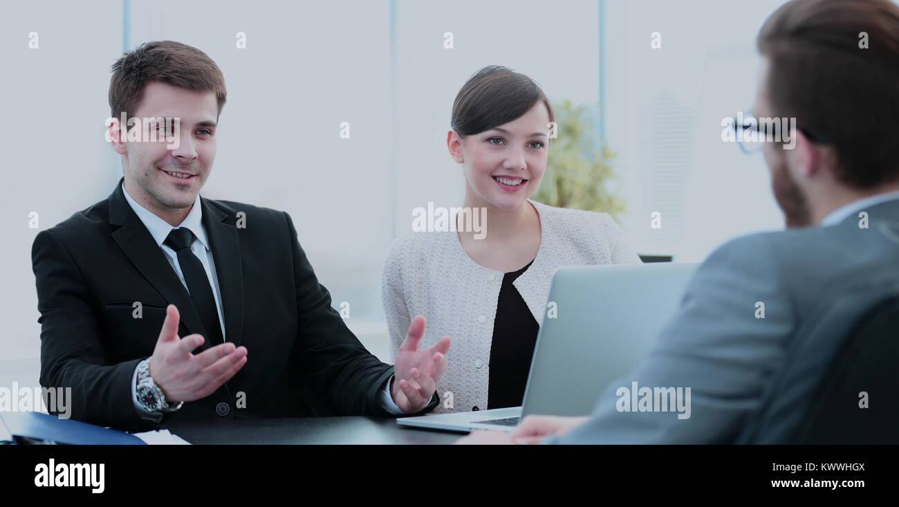 closeup of commercial Director sits at a Desk before an open laptop and ...