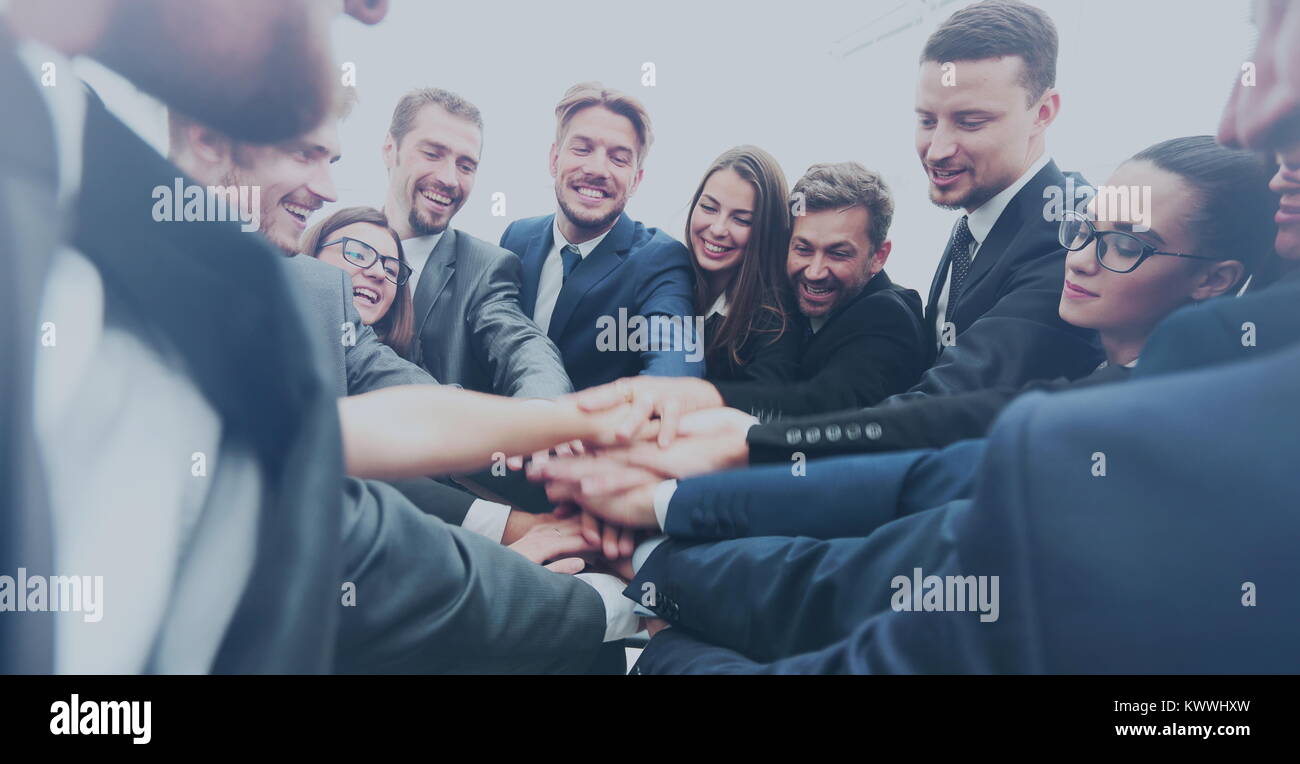 Large successfull business team showing unity with their hands together Stock Photo - Alamy