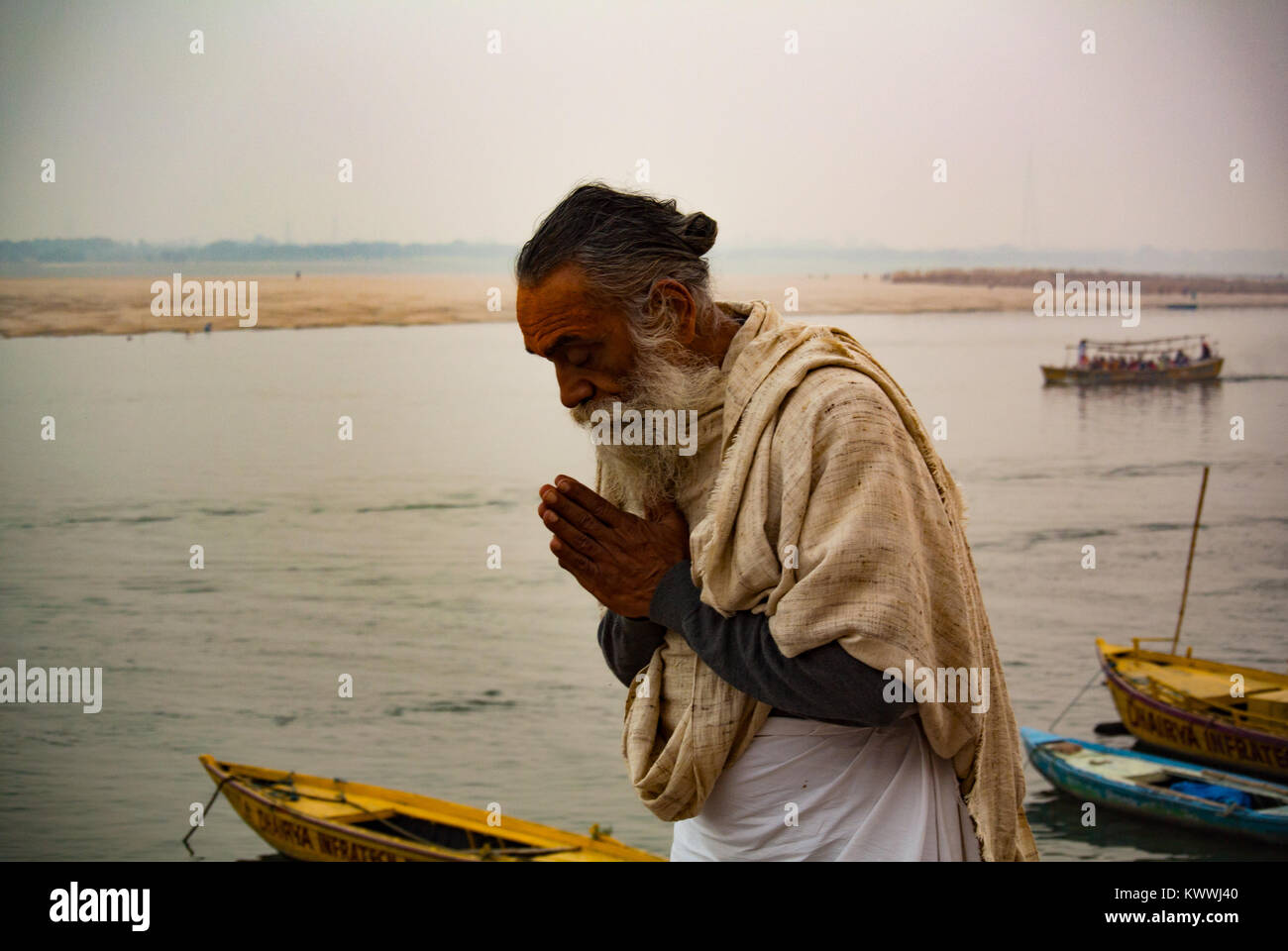 Indian male pilgrim praying to the mother Ganges river in a Hindu ...