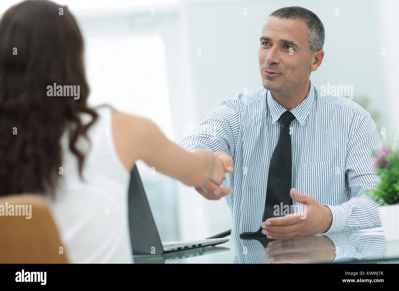 closeup.handshake Manager and client on the background of the office ...