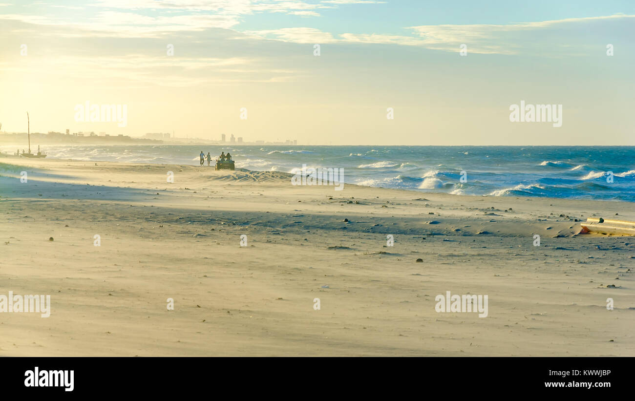 Buggy on the beach at the sunset with people around Stock Photo - Alamy