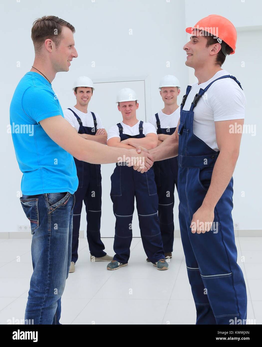 concept of cooperation. the handshake of the engineer and Builder Stock ...