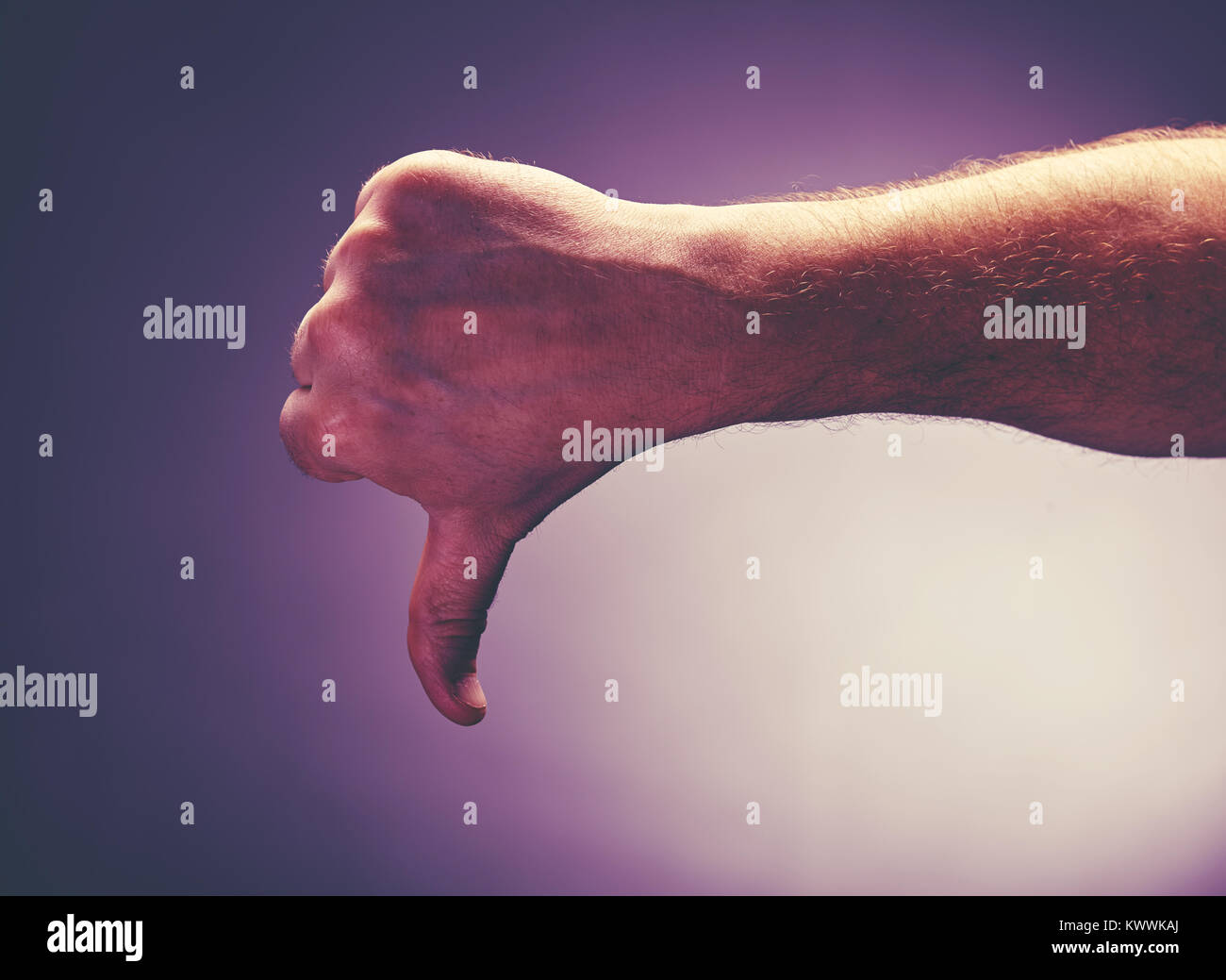 Thumb down male hand sign Stock Photo - Alamy
