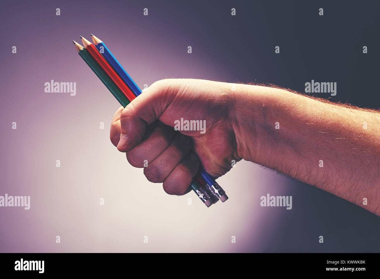 man holding up a pencil Stock Photo - Alamy