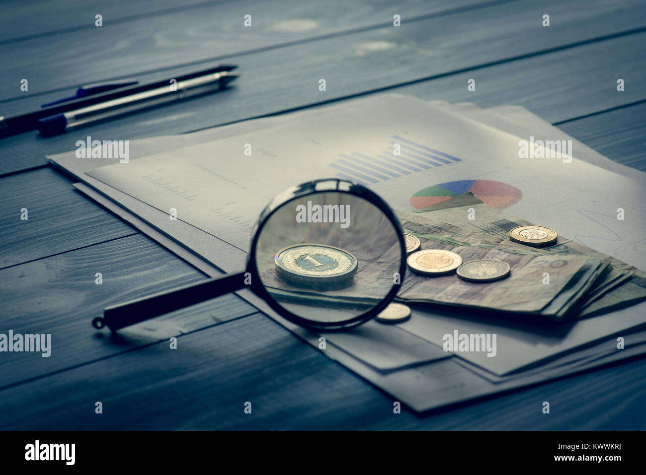 Polish money, notes and coins on the desk focusing on polsih 1 zloty ...