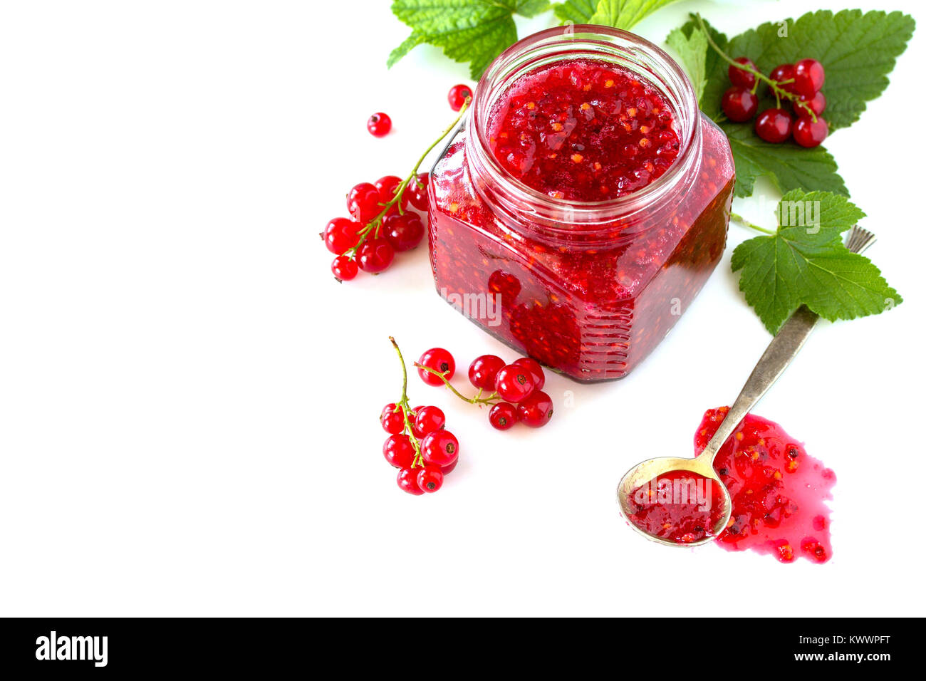 Homemade jam. Glass jar with red currant jam on white background ...