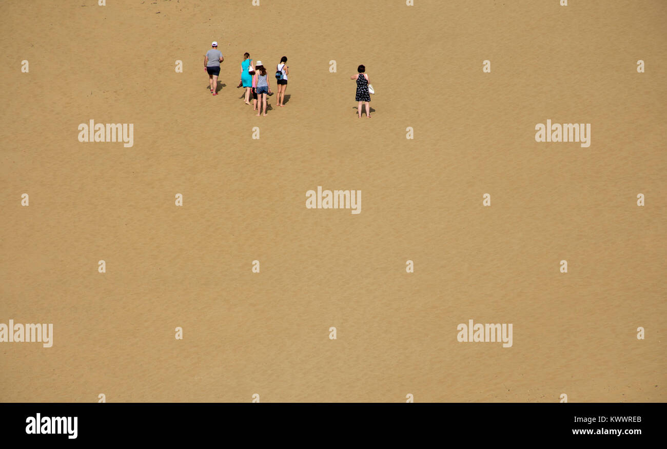 People walking on sand dunes (a place like a desert called "Ammothines ...