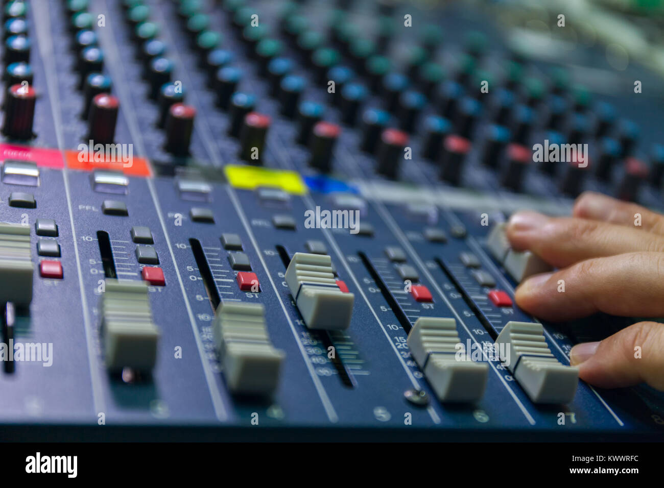 man's hand adjusting audio mixer. stock photo Stock Photo - Alamy
