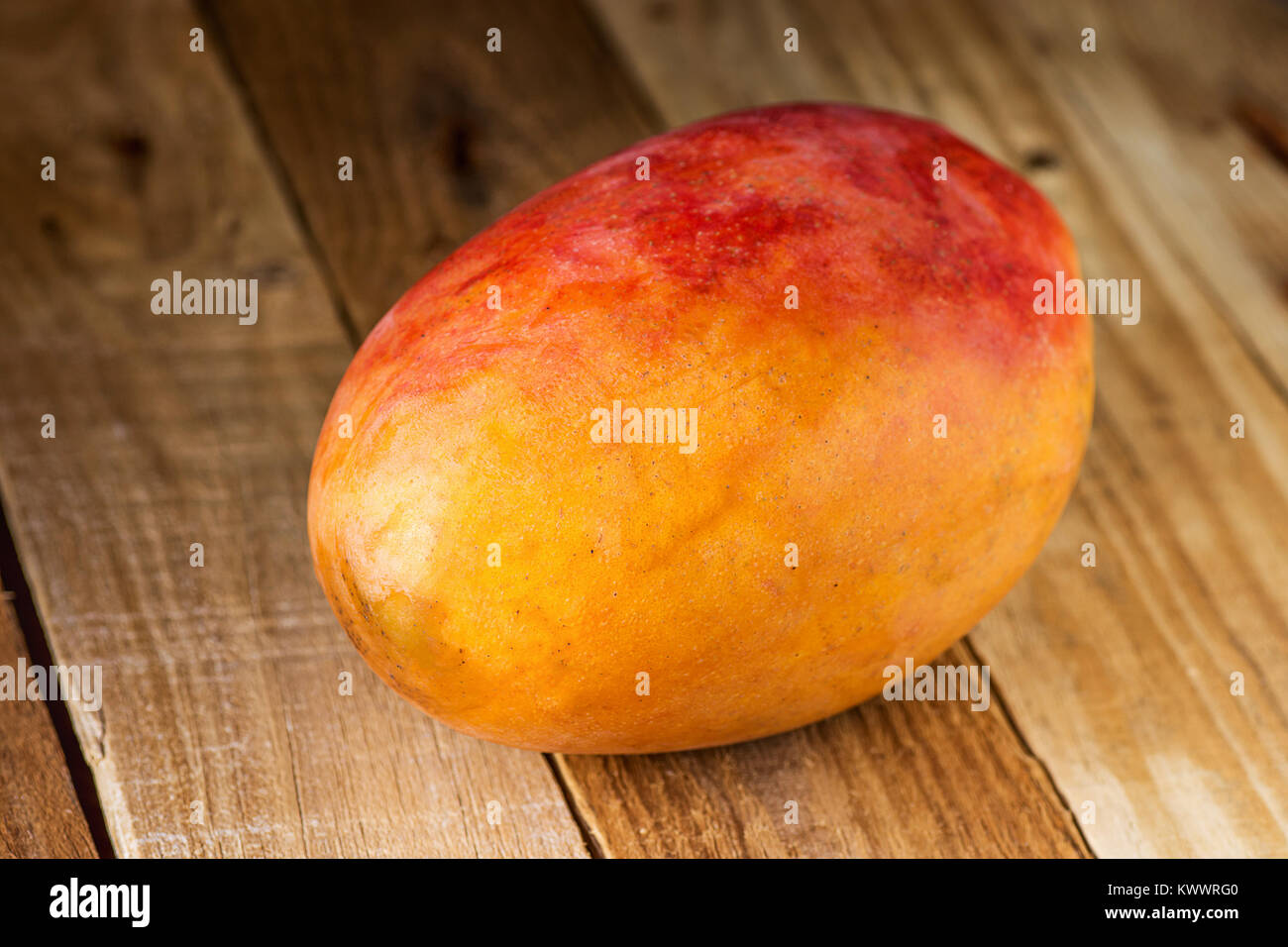 Ripe Colorful Red and Yellow Whole Mango on Weathered Wood Background ...