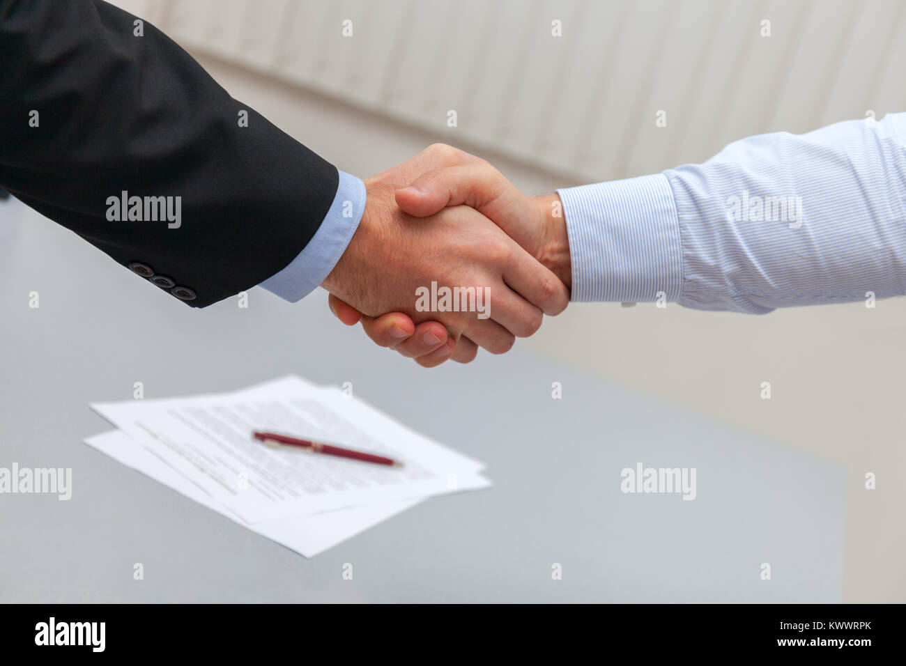 handshake after signing the contract. Two businessman shaking hands ...