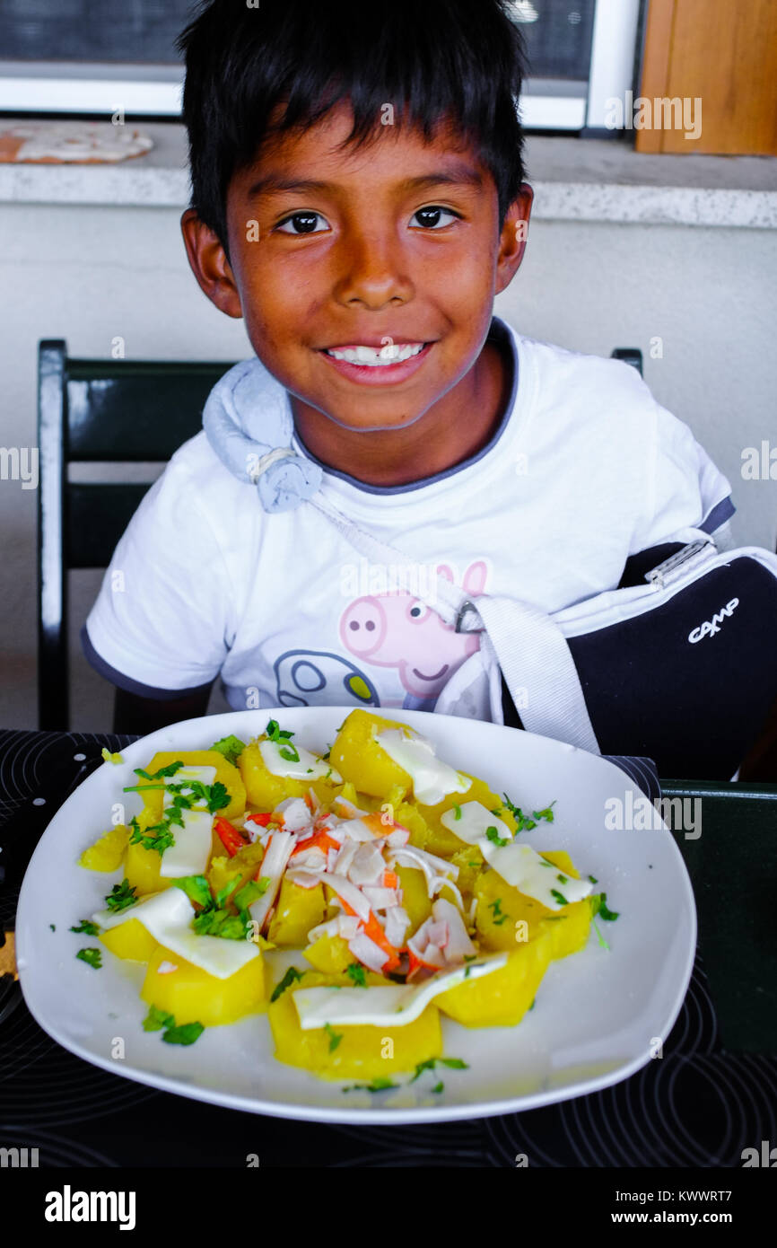 Happy latin boy smiling happy while ready to eat typical italian dish ...