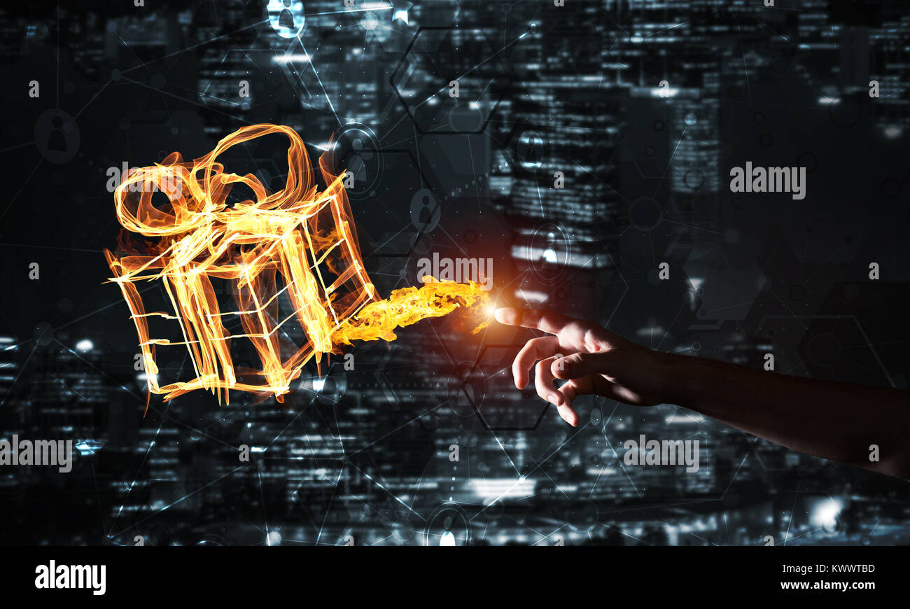 Glowing fire gift box icon on dark background Stock Photo - Alamy