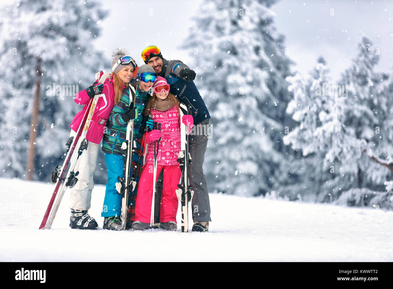 Family together skiing on snowy mountain and looking something in ...