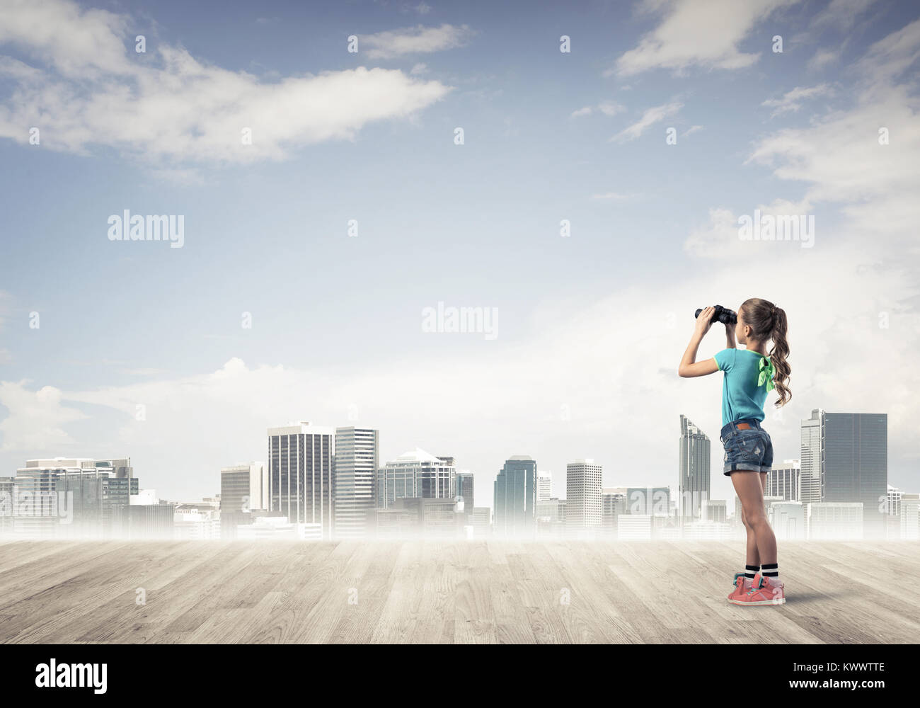 Cute kid girl standing on wooden floor and looking in binoculars Stock ...
