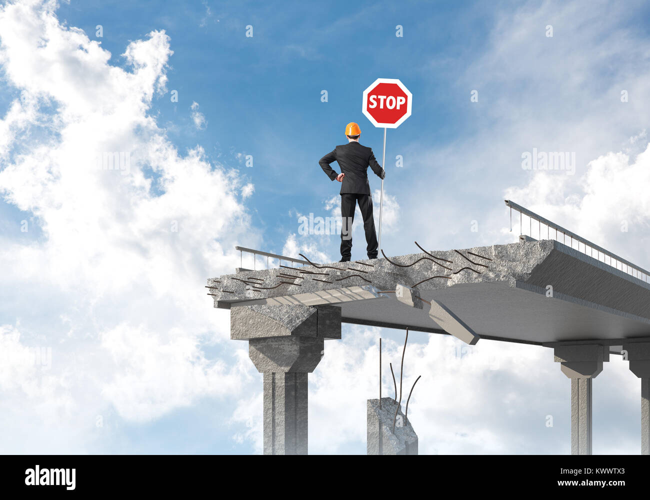 Rear view of engineer in helmet holding stop sign while standing on ...