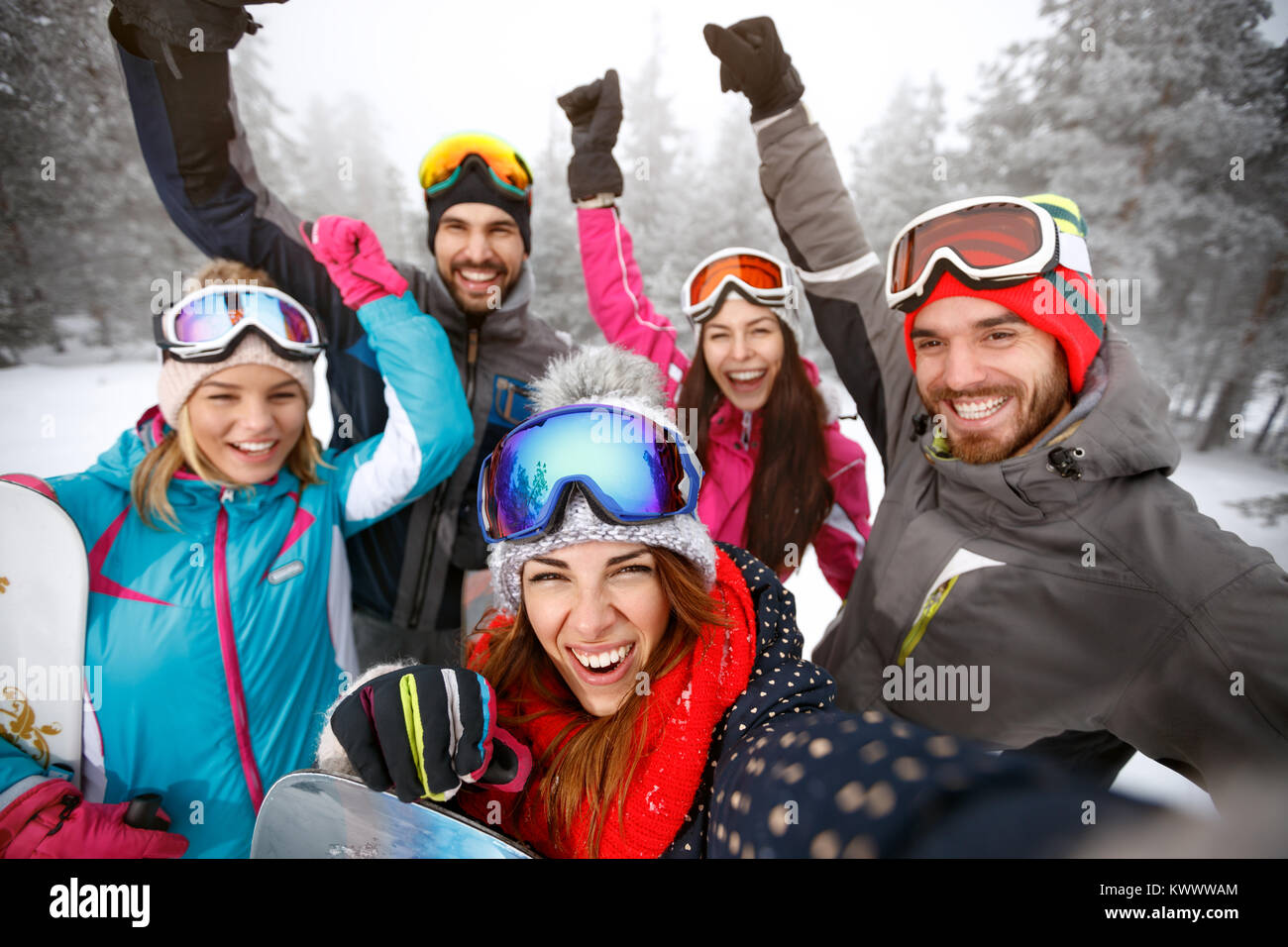 Cheerful young skiers on skiing together on snow Stock Photo - Alamy