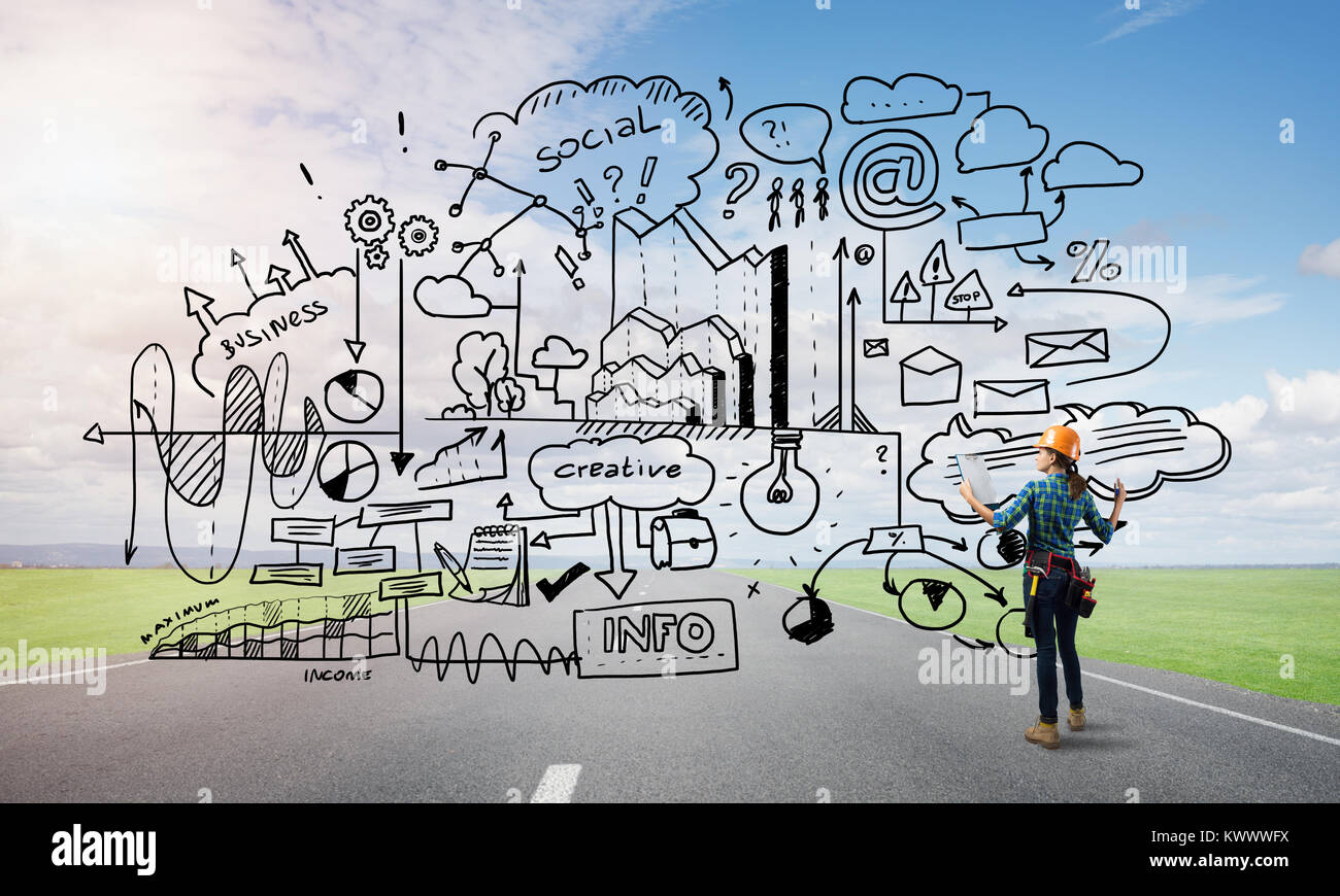 Back view of engineer woman in hardhat outdoor and sketched concept on ...
