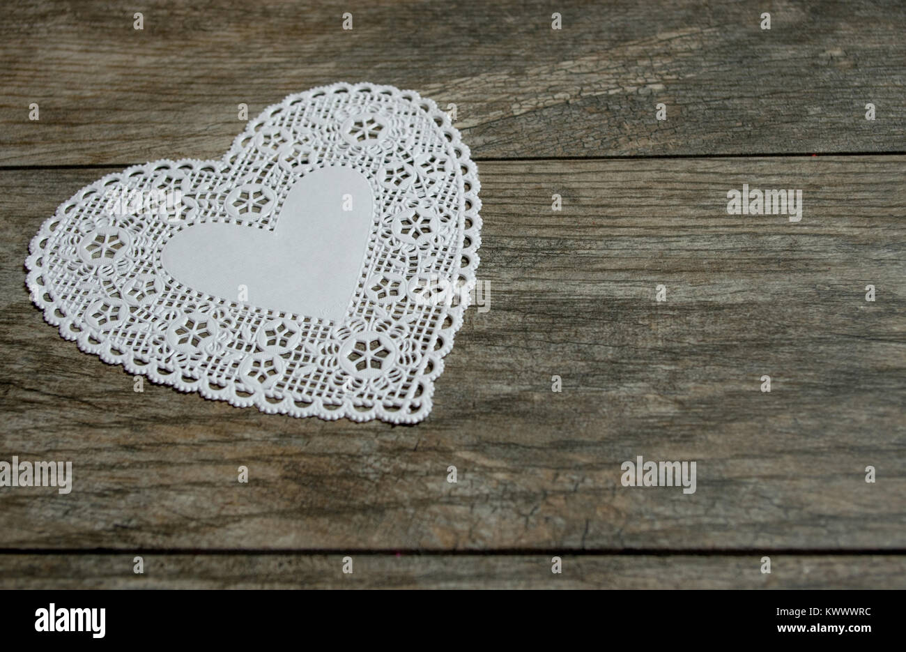 White lace heart on distressed wood background Stock Photo - Alamy