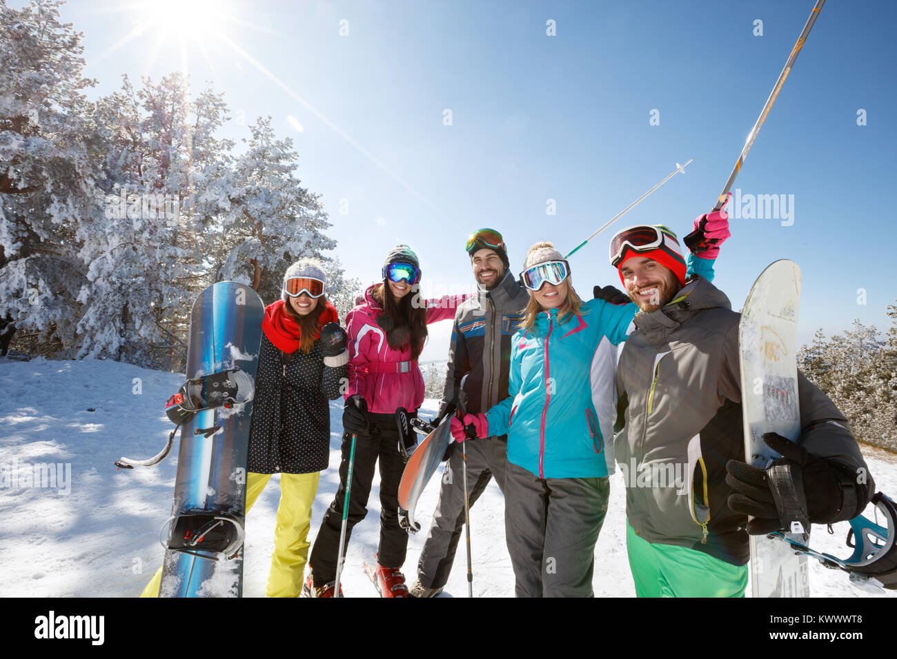 Happy skiers group together on snow Stock Photo - Alamy