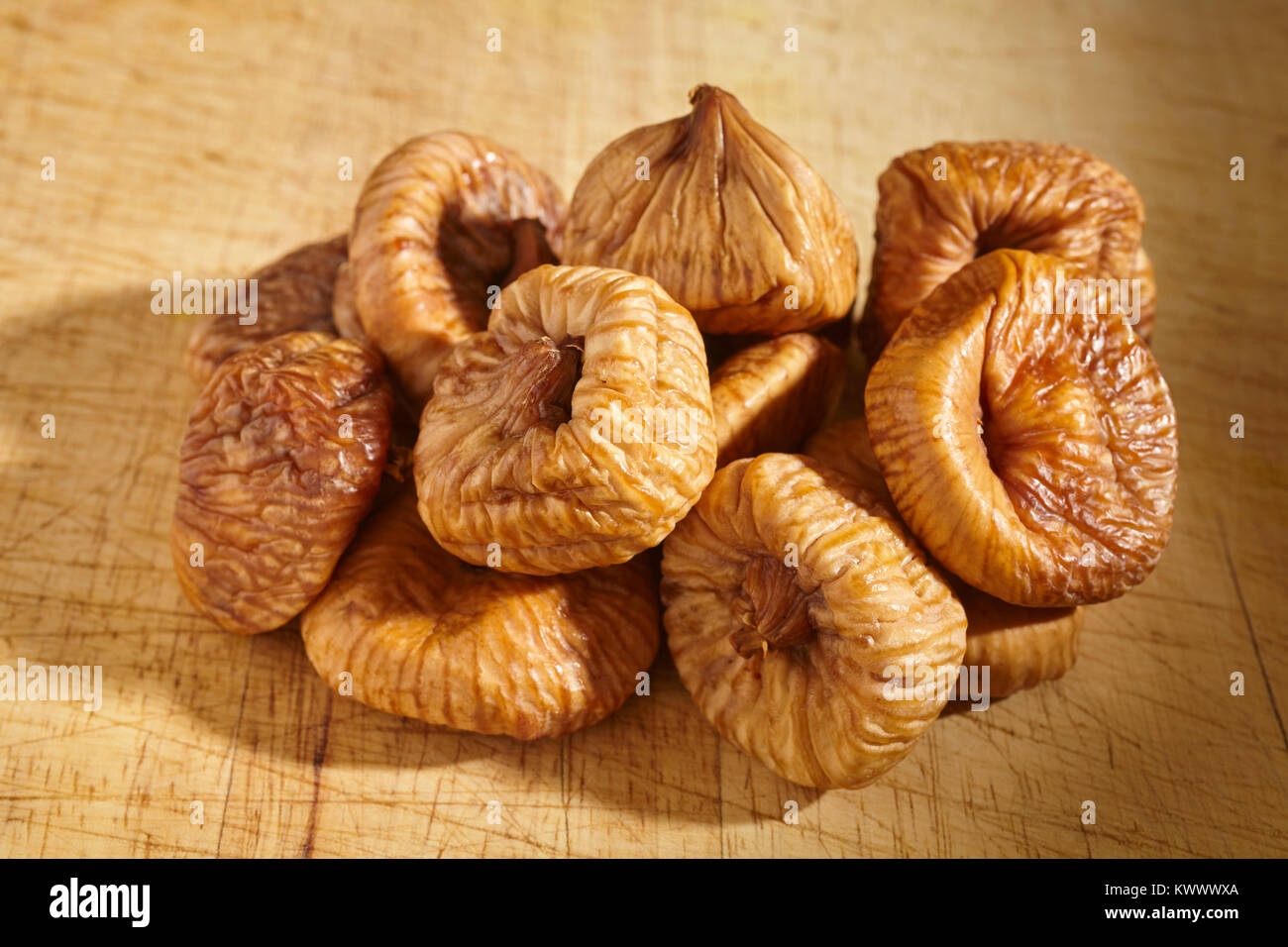 Dried figs on a wood cutting board Stock Photo - Alamy