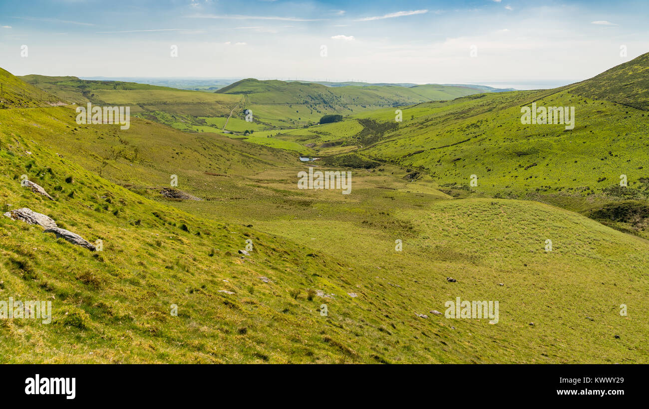 Welsh landscape with some wind turbines and the sea in the background ...