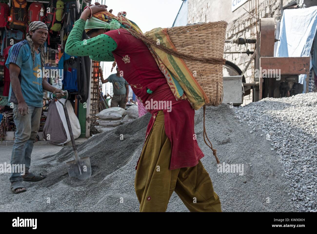 Women are carrying gravel stones on a construction site in Pokhara ...