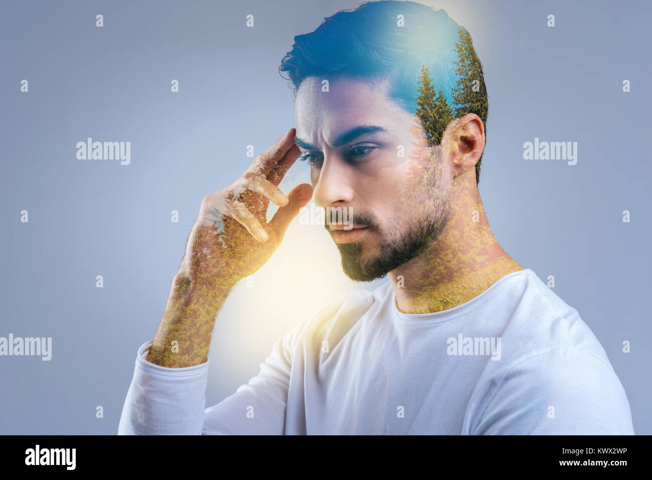 Creative thoughtful man imagining forest Stock Photo - Alamy