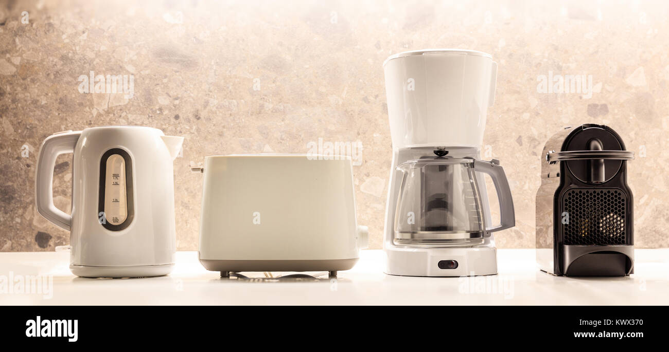 Modern kitchen appliances placed on white surface. Colorful, blurred ...