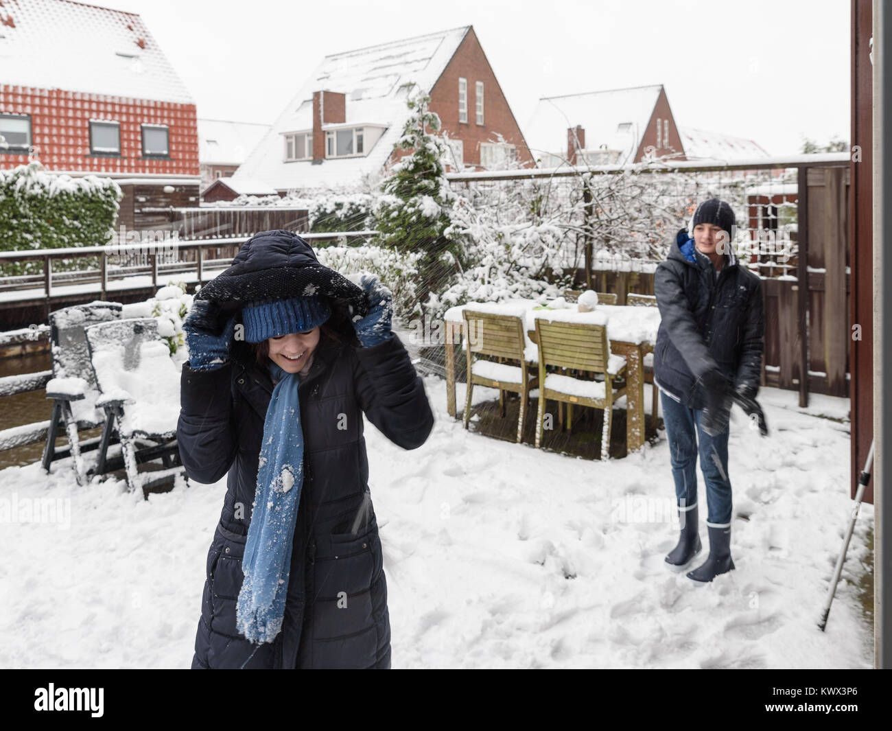 Children throwing snowballs hi-res stock photography and images - Alamy