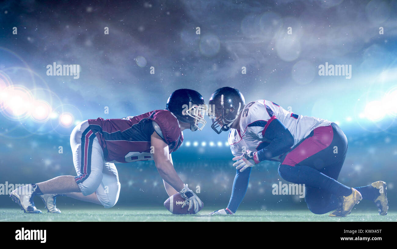 american football players are ready to start a match on modern field at ...