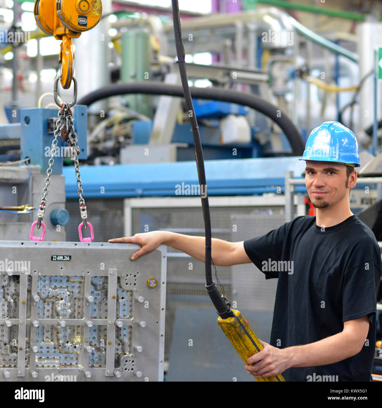 worker operates a crane in an industrial plant - interior in a factory ...