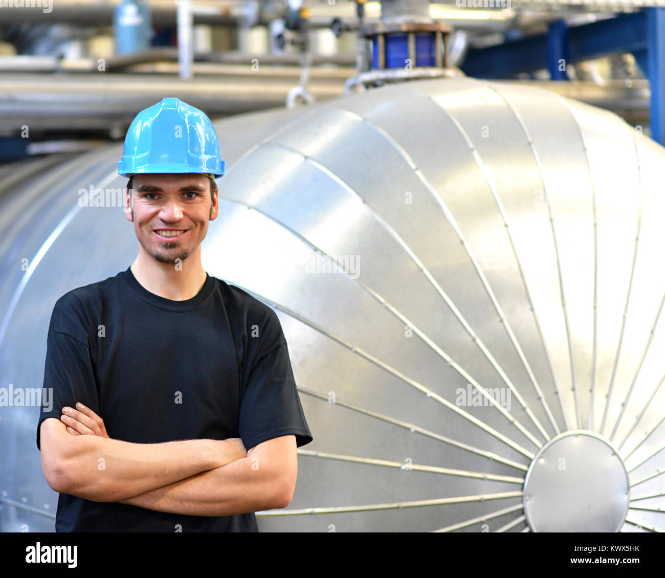 operator repairs a machine in an industrial plant with tools Stock ...