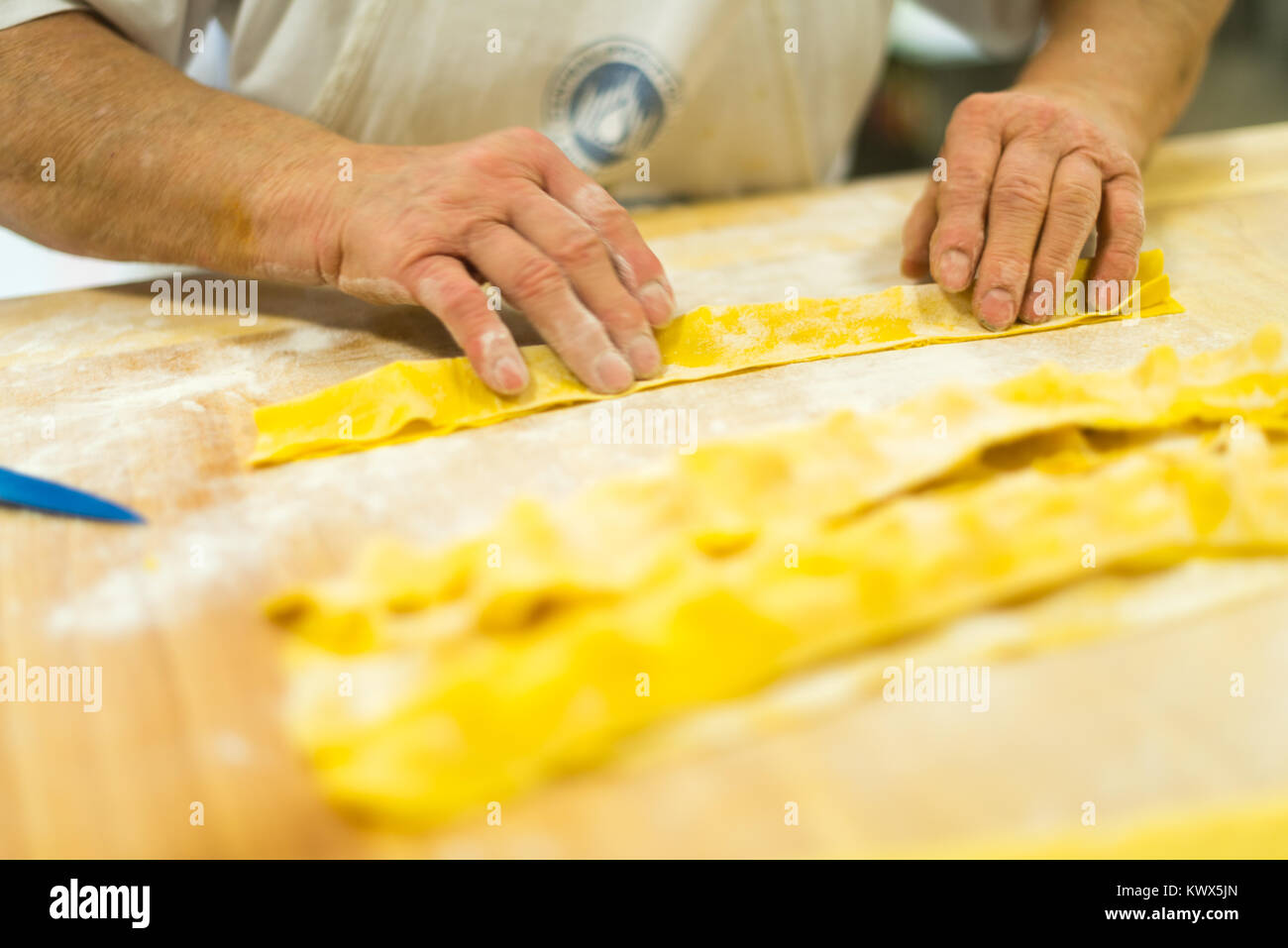 Caucasian italian 70s 80s senior lady with wrinkled hands preparing ...