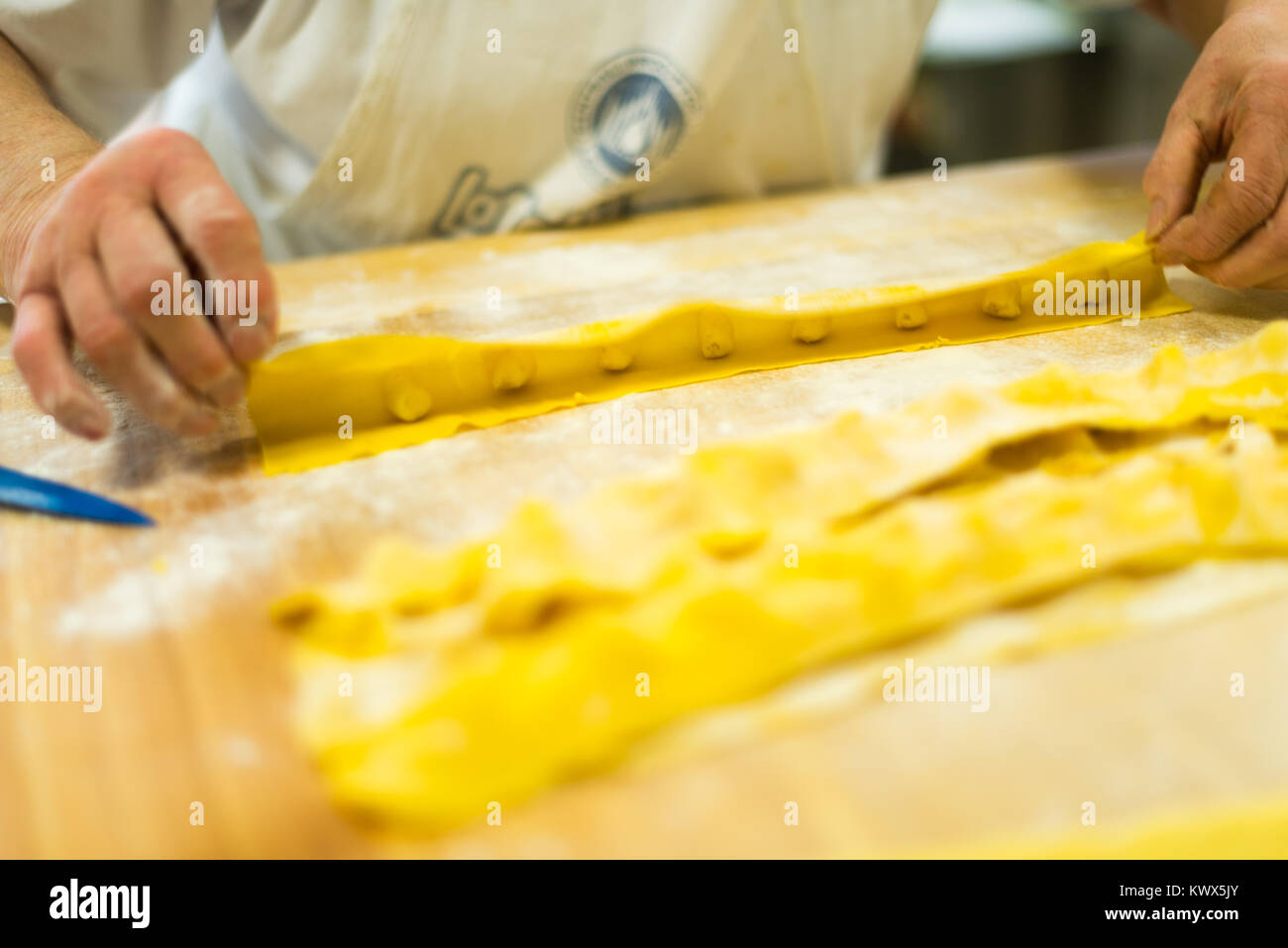 Caucasian italian 70s 80s senior lady with wrinkled hands preparing ...