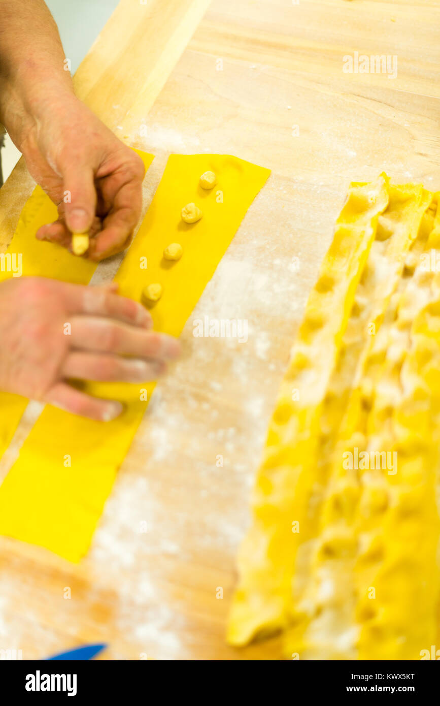 Caucasian italian 70s 80s senior lady with wrinkled hands preparing ...