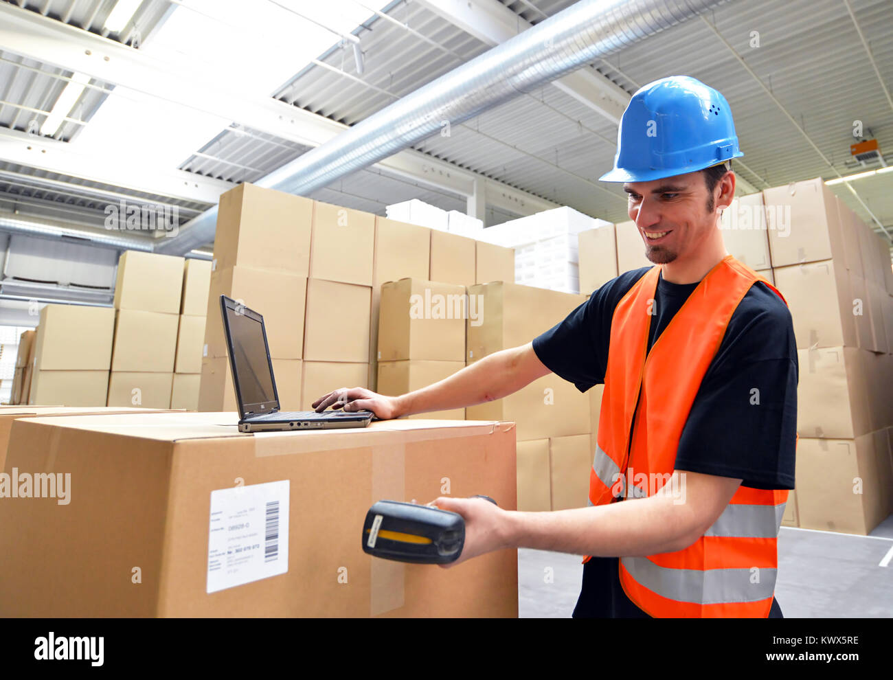 logistics worker - man scans parcels of goods and prepares the dispatch ...