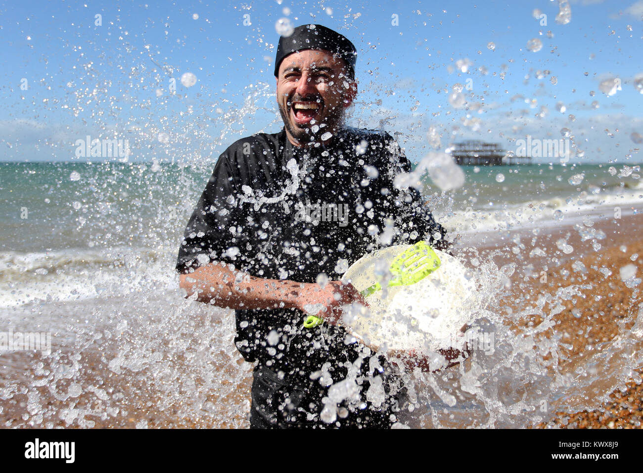 A chef pictured posing on Brighton seafront with cooking equipment ...
