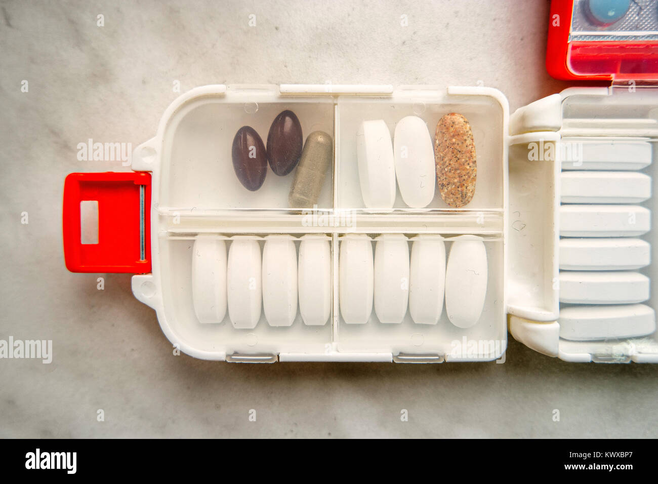 Open pillbox with a lot of tablets ready for use top view Stock Photo ...